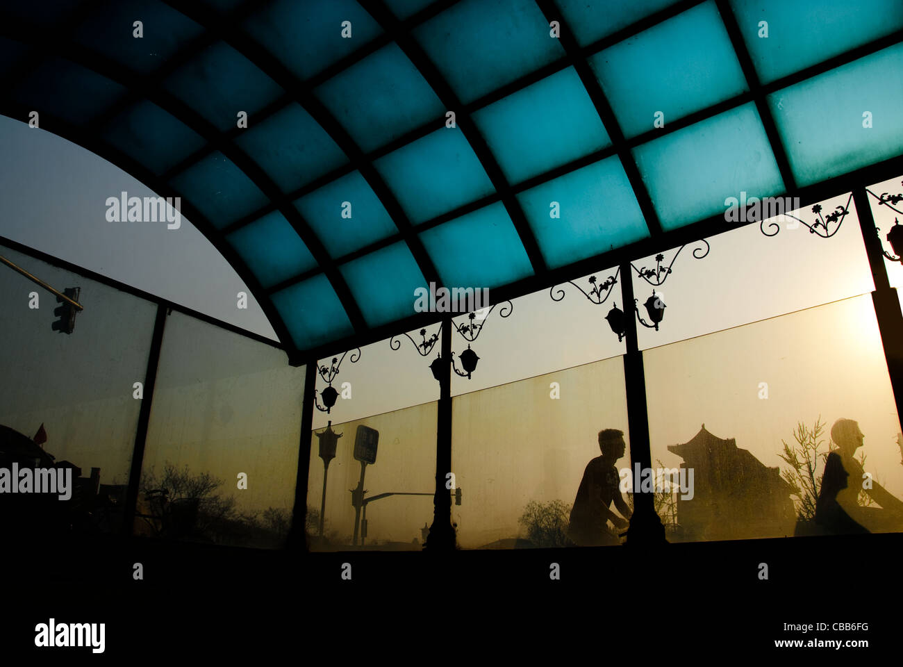 Silhouettes through a window of a pedestrian tunnel at Tiananmen Square ...