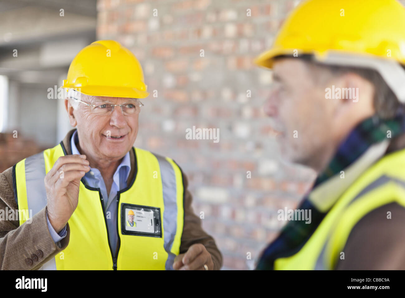 Construction workers talking on site Stock Photo - Alamy