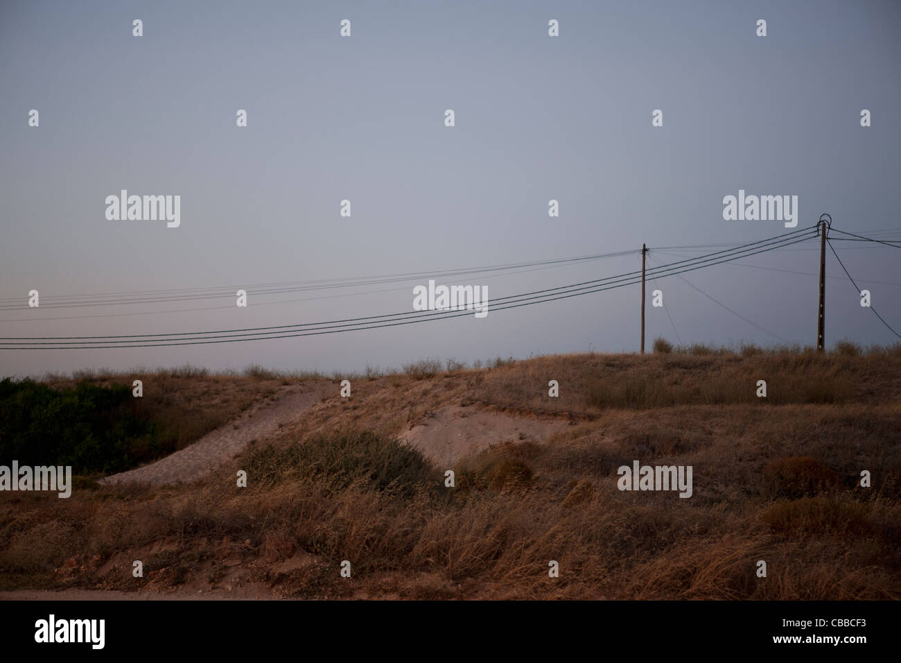 Electricity cables over sand dunes Stock Photo - Alamy