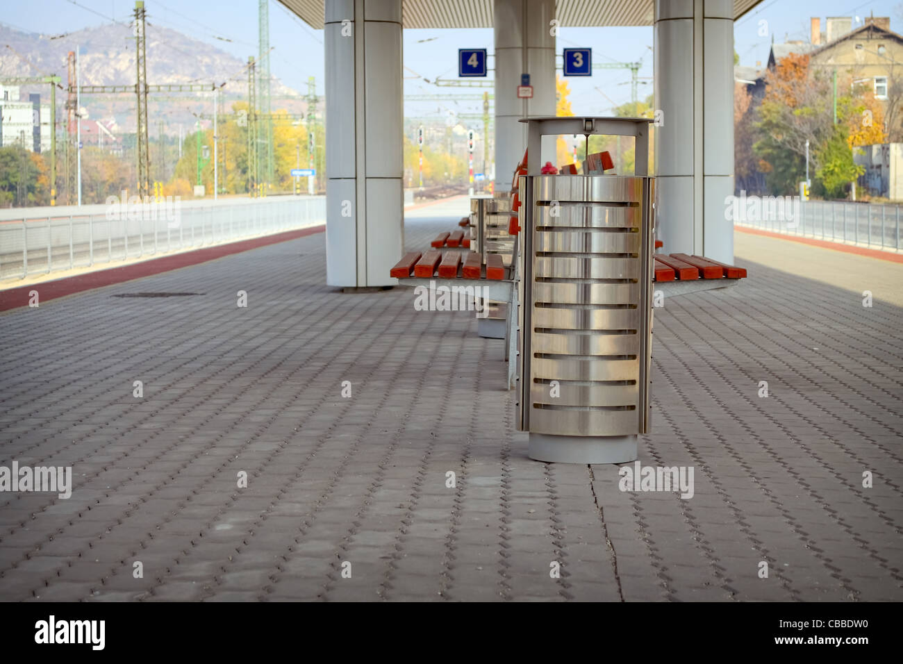Metal trash can on a railway station Stock Photo - Alamy