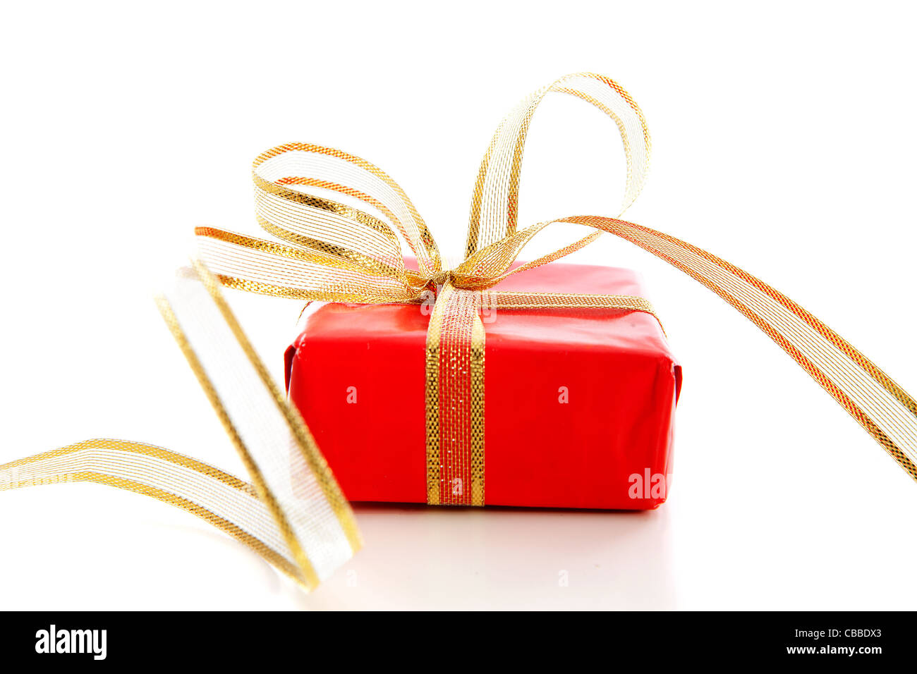 Red present with golden bow over white background Stock Photo - Alamy