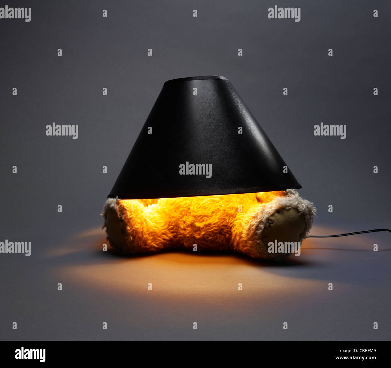 Teddy bear with lamp shade Stock Photo - Alamy