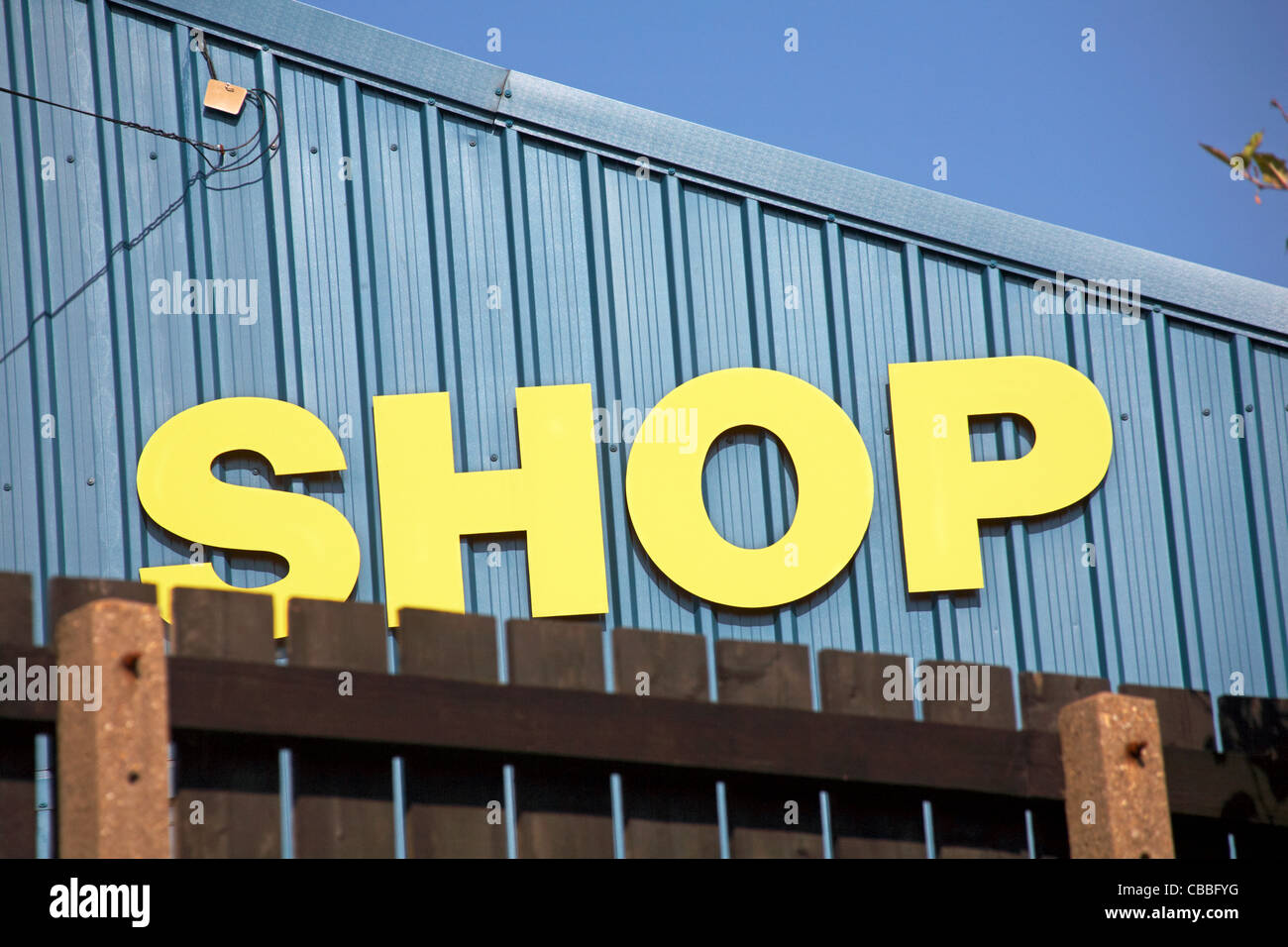SHOP part of yellow sign on side of building Stock Photo - Alamy