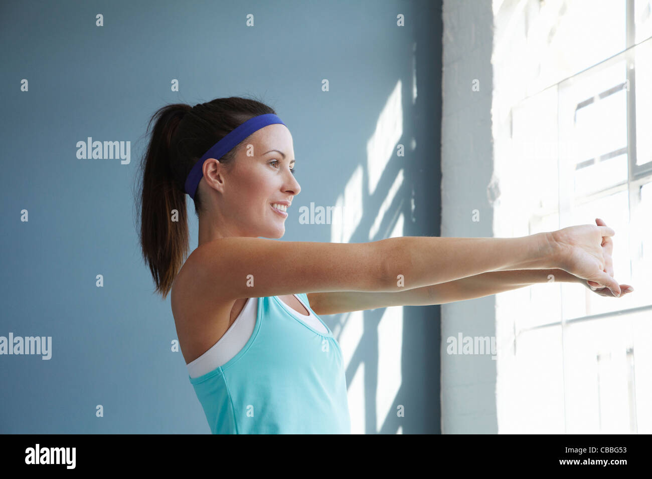 Woman stretching indoors Stock Photo - Alamy