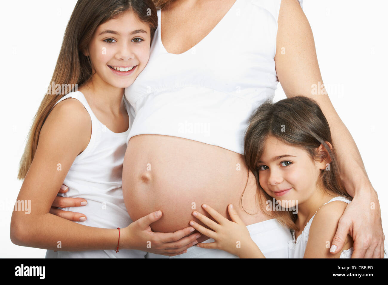 Girls hugging pregnant mother’s belly Stock Photo - Alamy