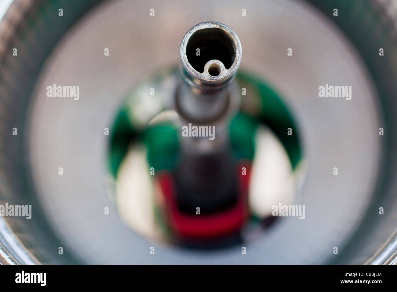 A view from car's tank to a fuel-pistol serving petrol at gas, petrol ...