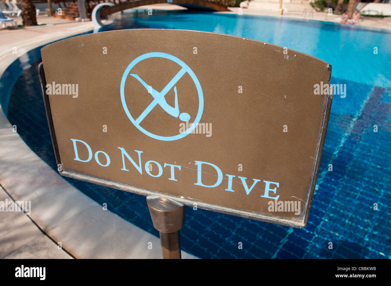 do not dive sign with blue water in background Stock Photo - Alamy