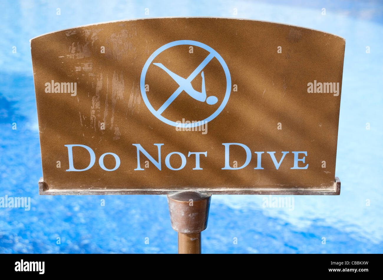 do not dive sign with blue water in background Stock Photo - Alamy