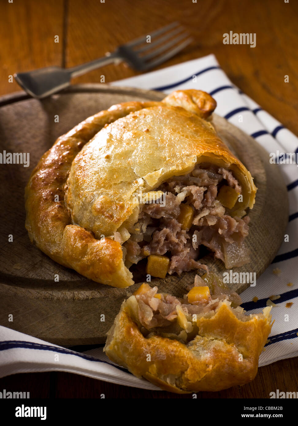 Sliced Cornish Pasty on chopping board Stock Photo - Alamy