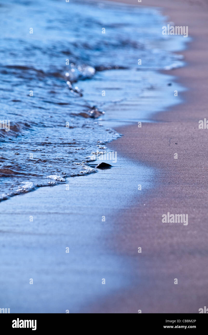 dreamy sea shore with blue waves washing sandy beach Stock Photo - Alamy