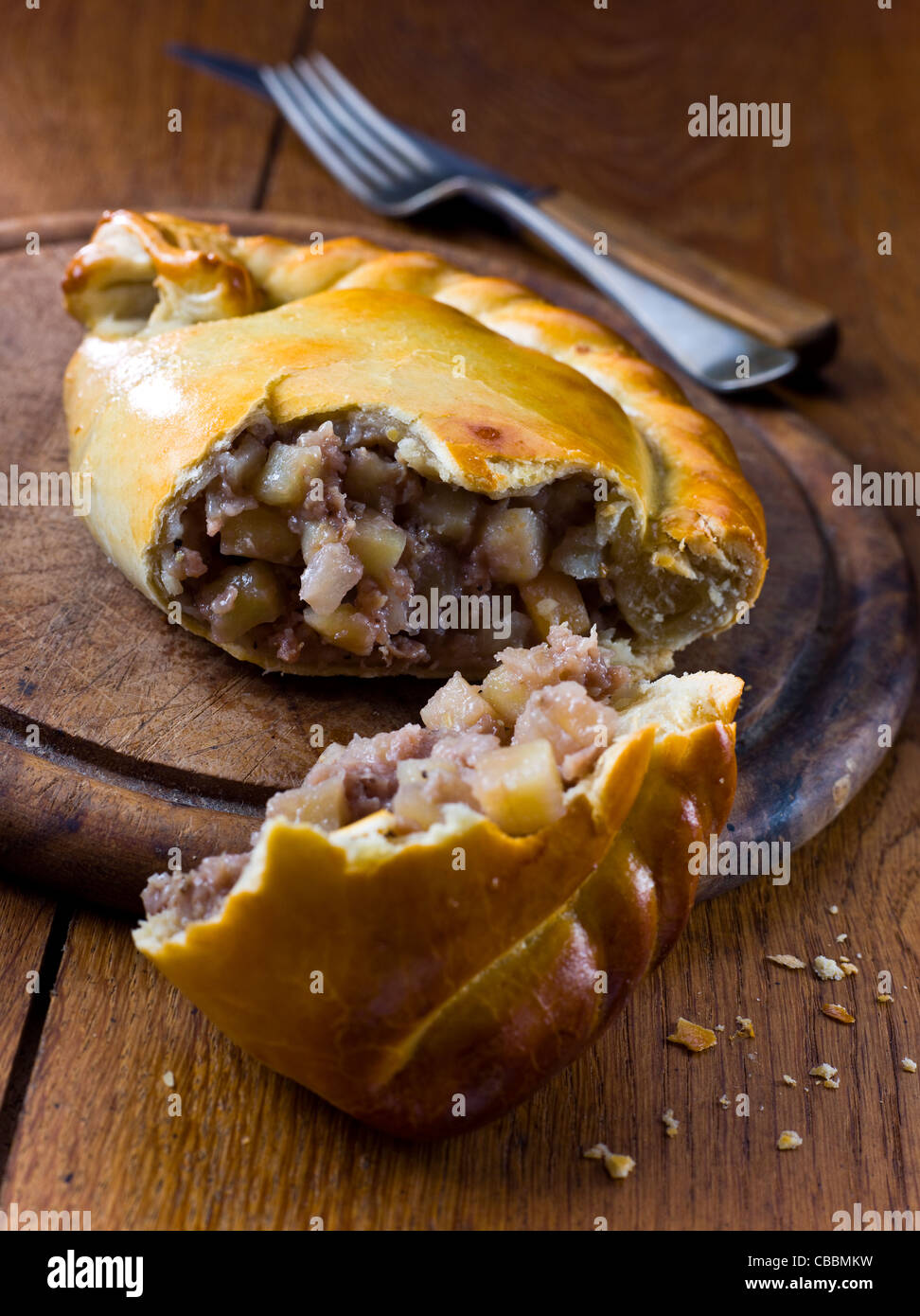 Sliced Cornish Pasty on chopping board Stock Photo - Alamy