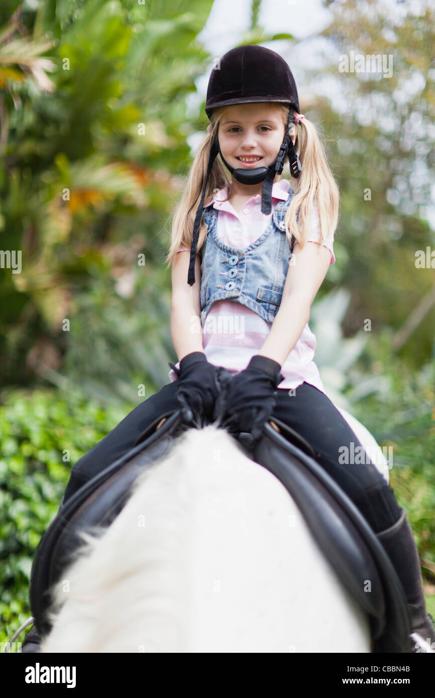 Smiling Girl Riding Horse In Park Stock Photo Alamy