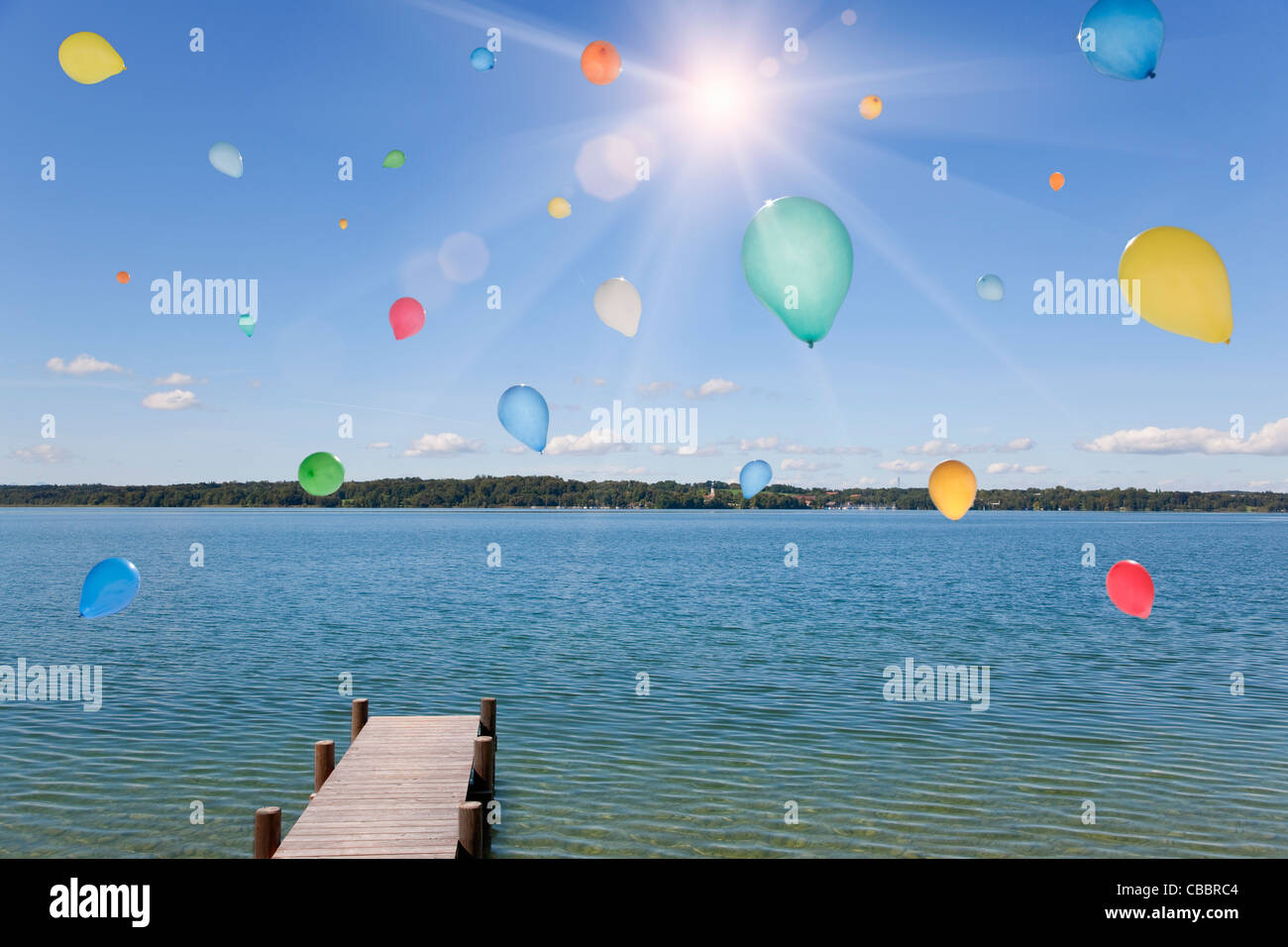 Balloons floating over still lake Stock Photo - Alamy