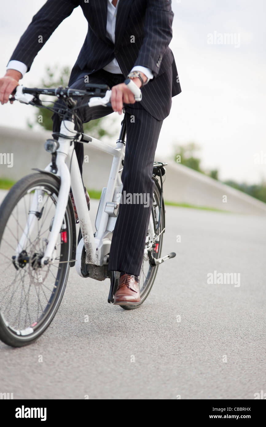 Businessman cycling in park hi-res stock photography and images - Alamy