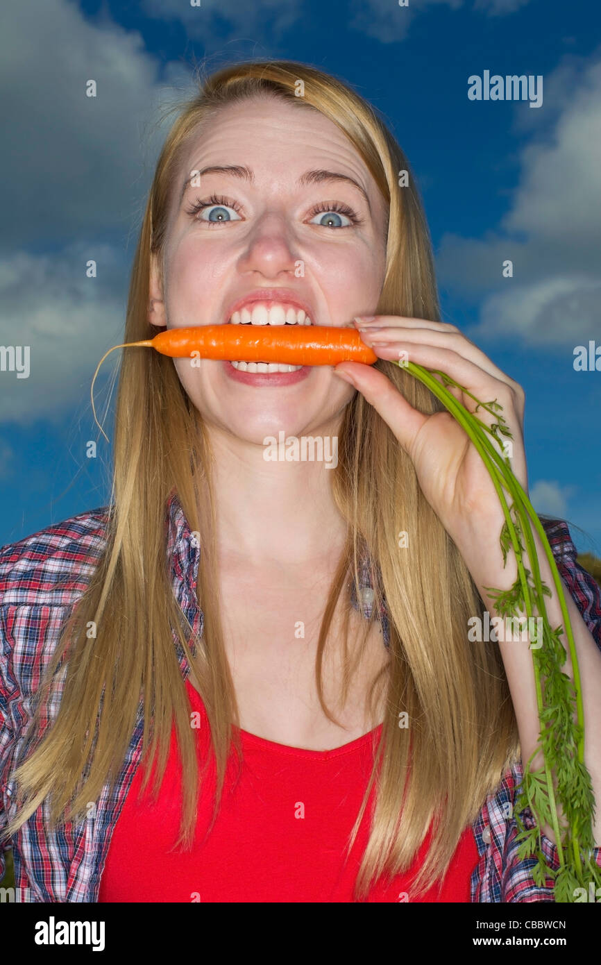 Woman biting carrot hi-res stock photography and images - Alamy