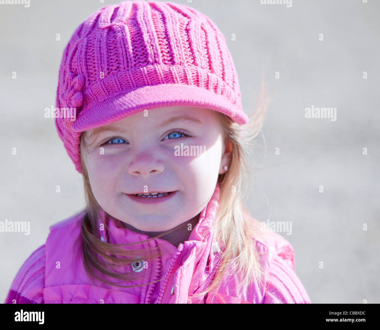 Pretty girl in pink outside in sunlight portrait Stock Photo - Alamy