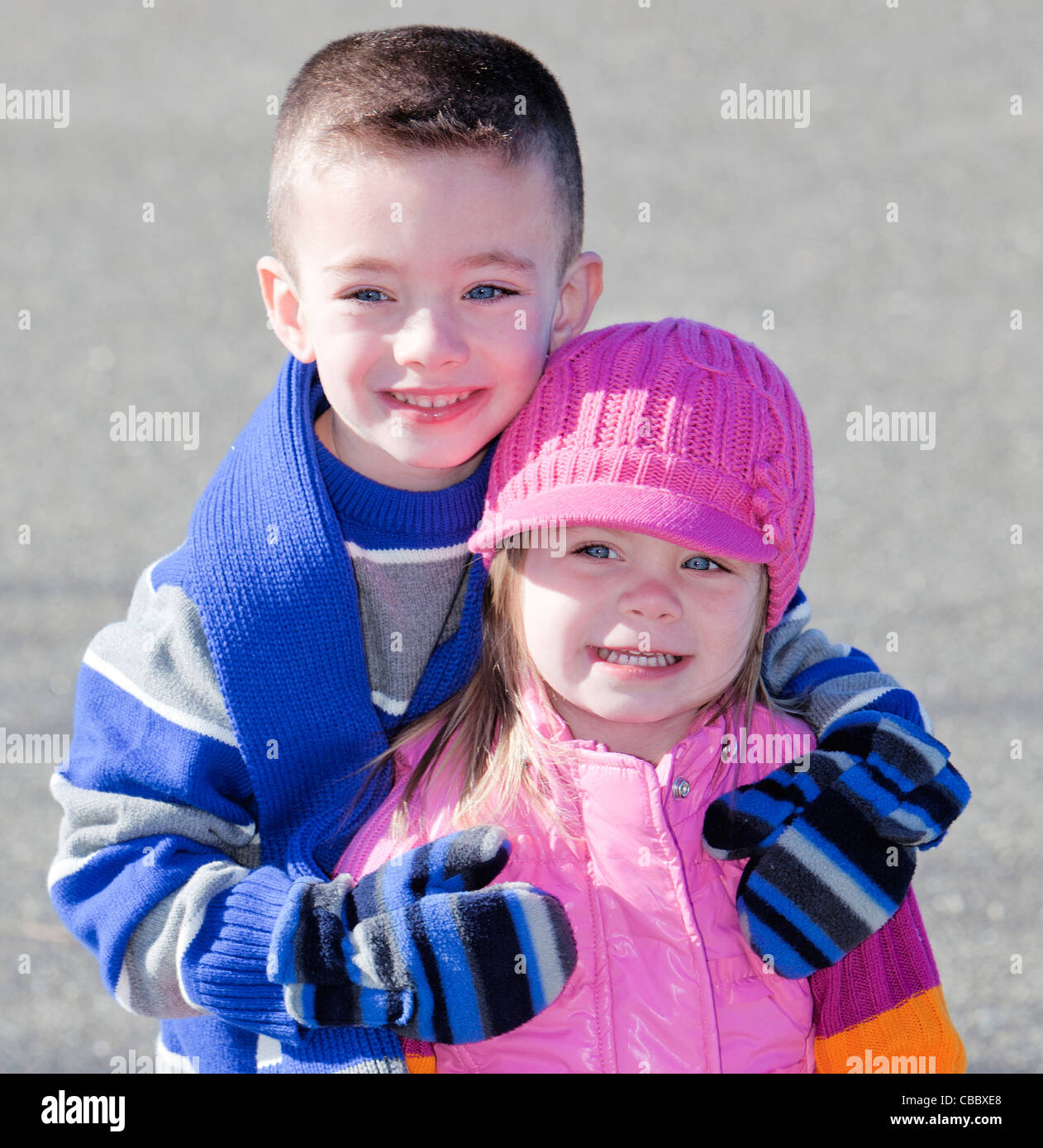 Cute brother and sister in winter hugging outside Stock Photo - Alamy