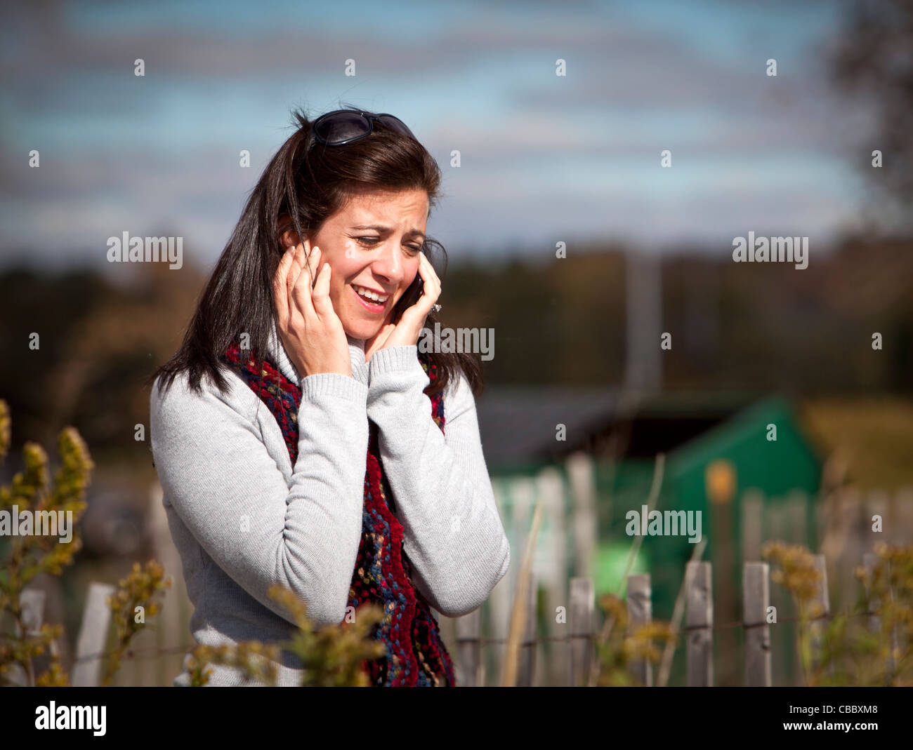 Pretty woman looking concerned whilst making a phone call Stock Photo ...