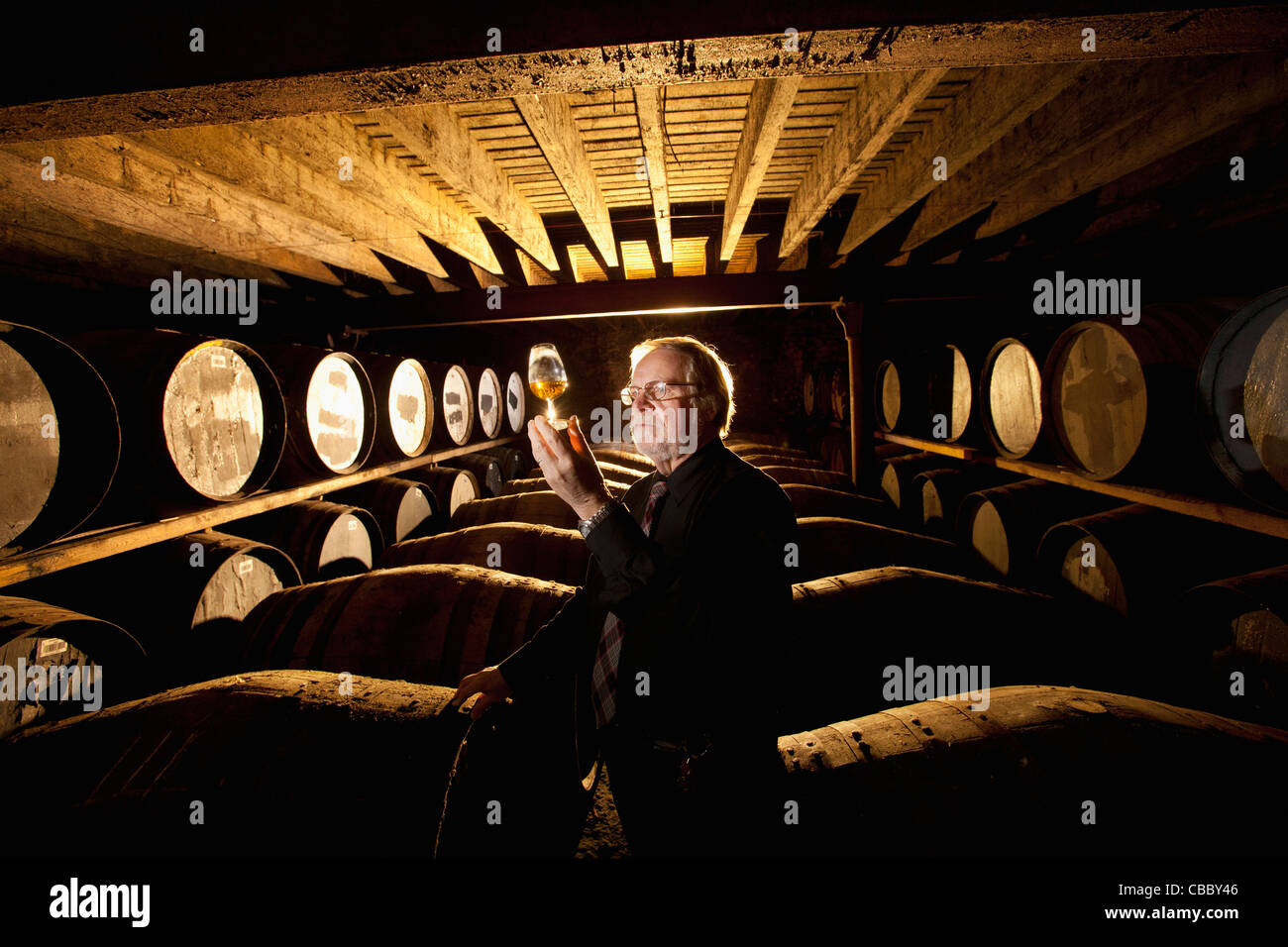 Worker testing whisky in distillery Stock Photo - Alamy