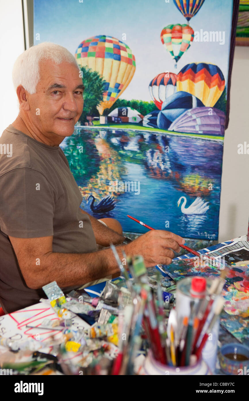 Older artist painting in studio Stock Photo - Alamy