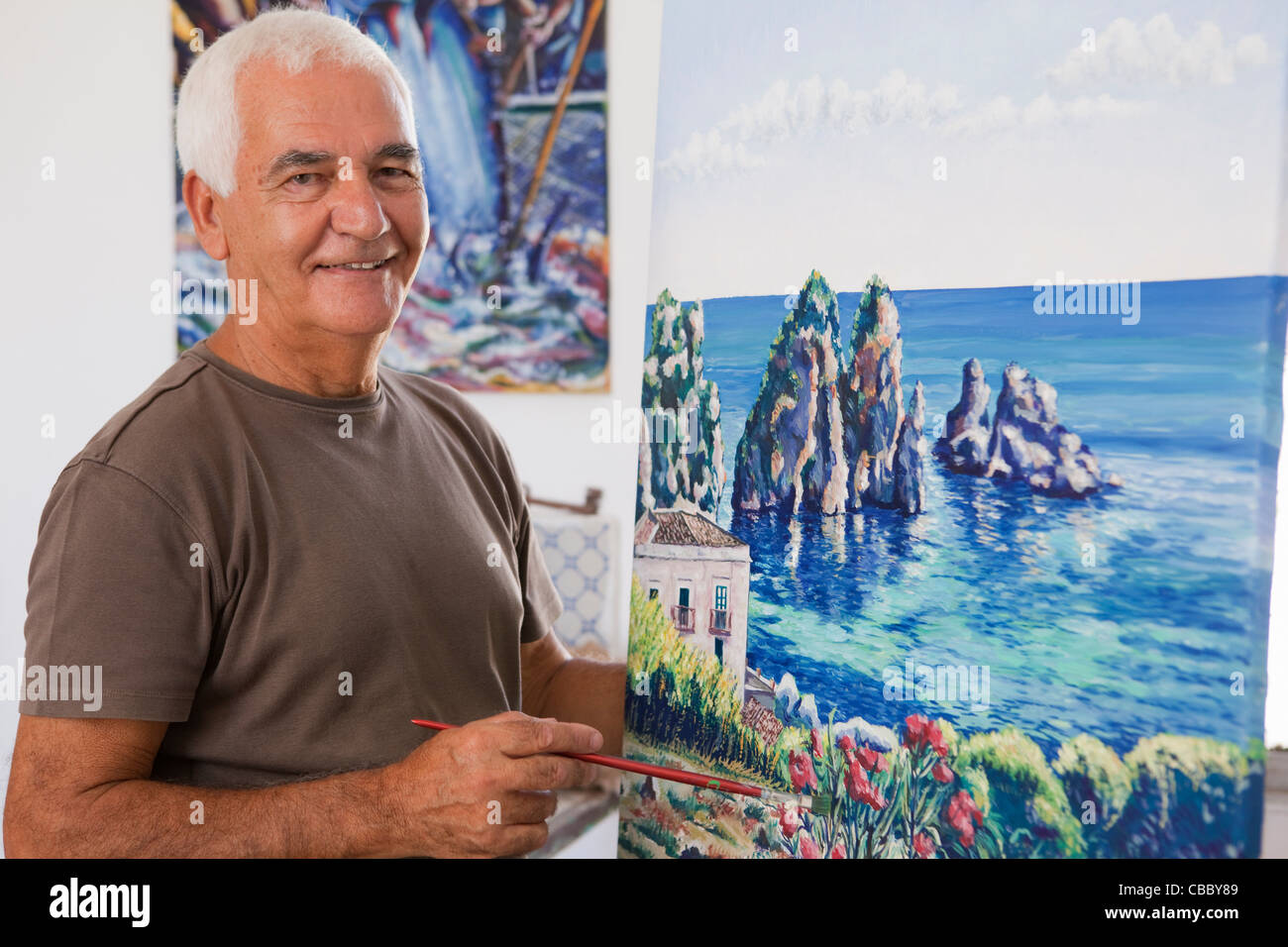 Older artist painting in studio Stock Photo - Alamy