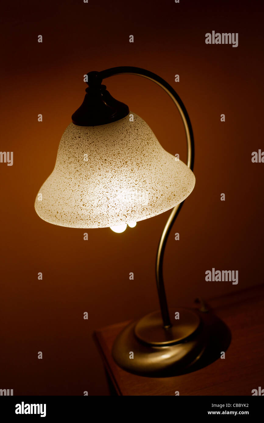 Small lamp glowing in a dark room Stock Photo - Alamy
