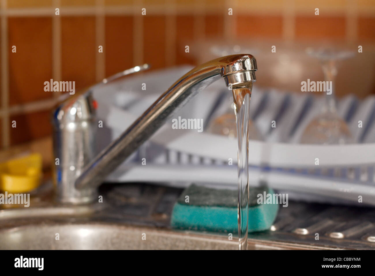 Water flowing from a kitchen tap Stock Photo - Alamy