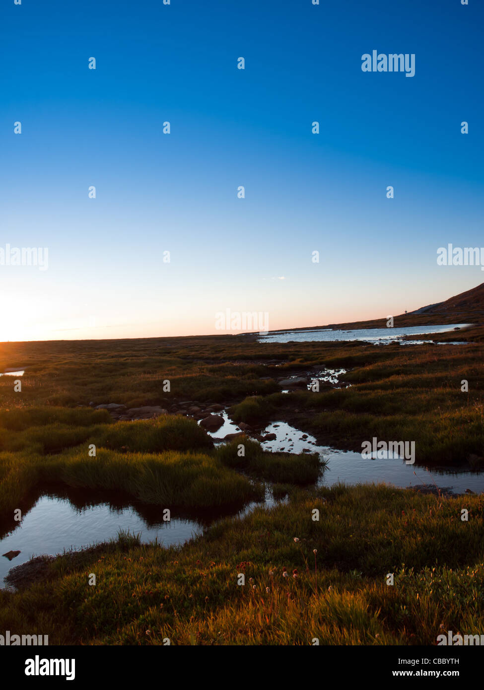 Beautiful Summit Lake reflects towering Mt. Evans and is surrounded by ...