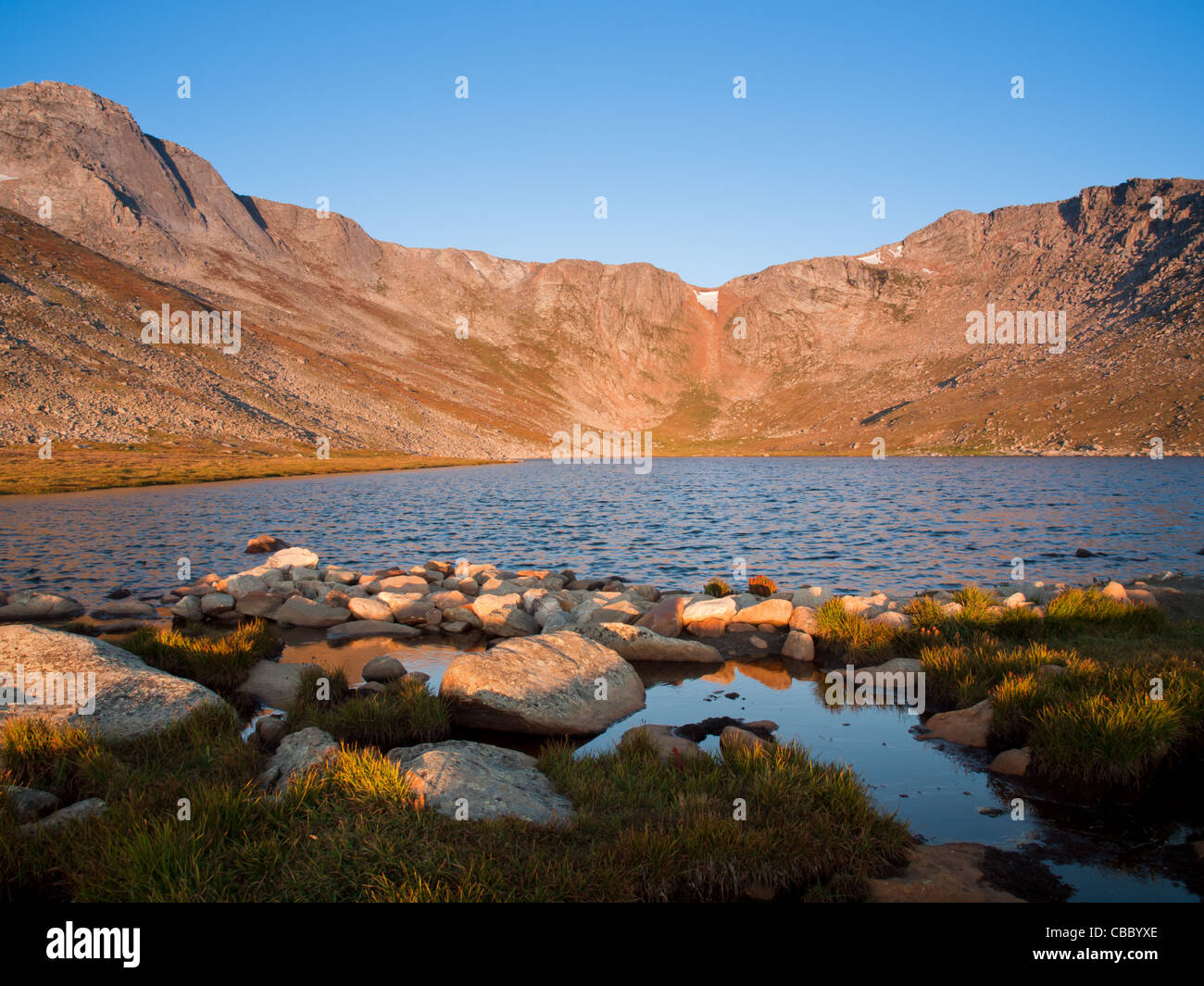 Beautiful Summit Lake reflects towering Mt. Evans and is surrounded by ...