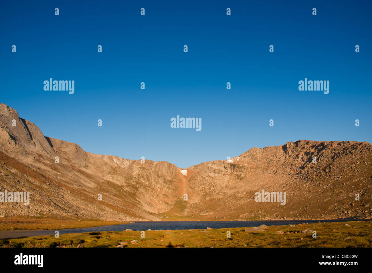 Beautiful Summit Lake reflects towering Mt. Evans and is surrounded by ...