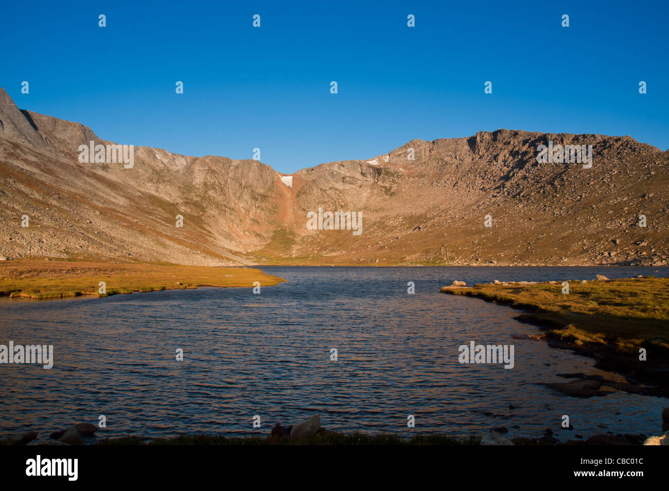Beautiful Summit Lake reflects towering Mt. Evans and is surrounded by ...