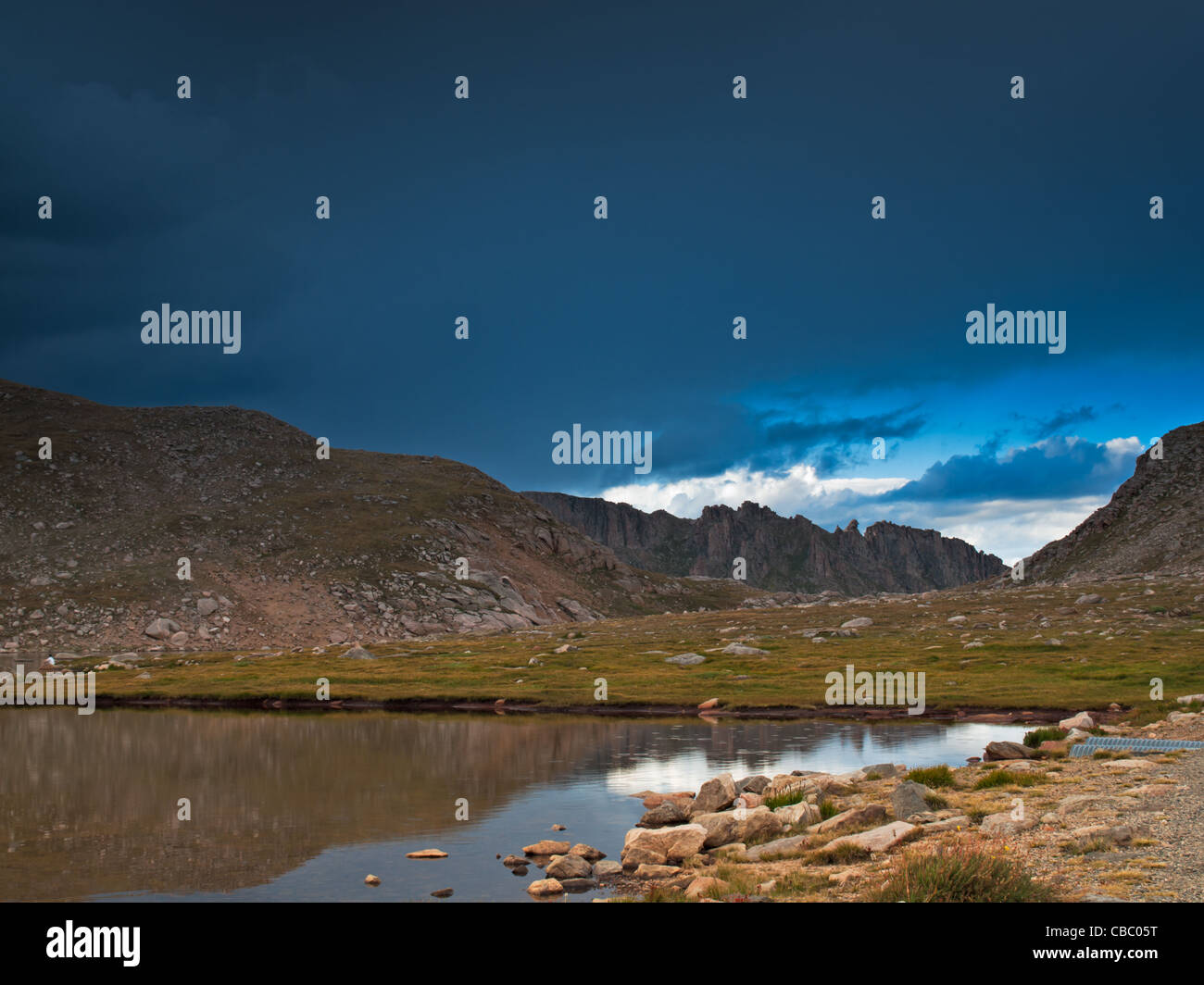 Beautiful Summit Lake reflects towering Mt. Evans and is surrounded by ...