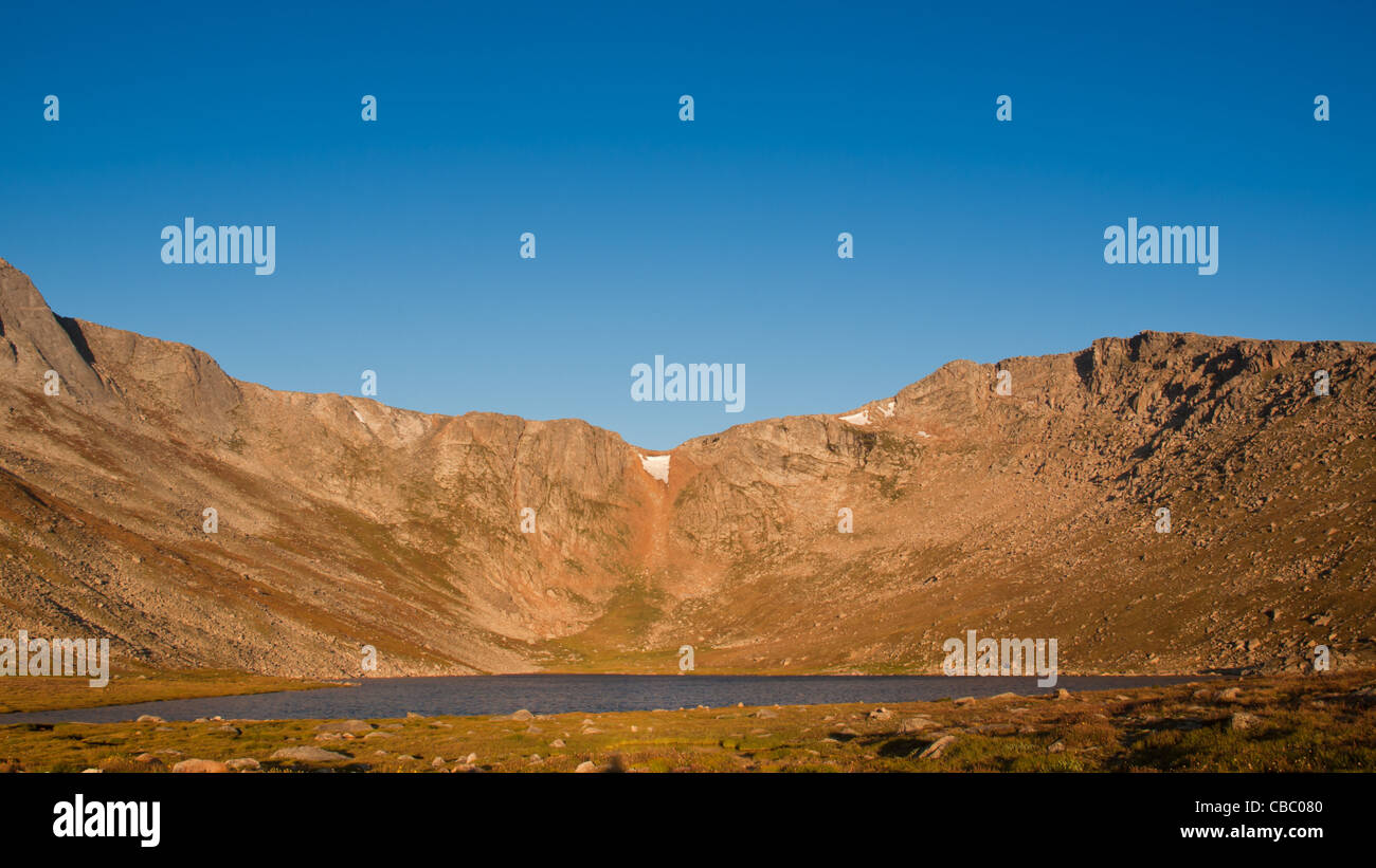 Beautiful Summit Lake reflects towering Mt. Evans and is surrounded by ...