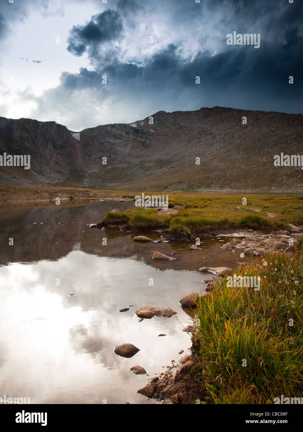 Beautiful Summit Lake reflects towering Mt. Evans and is surrounded by ...