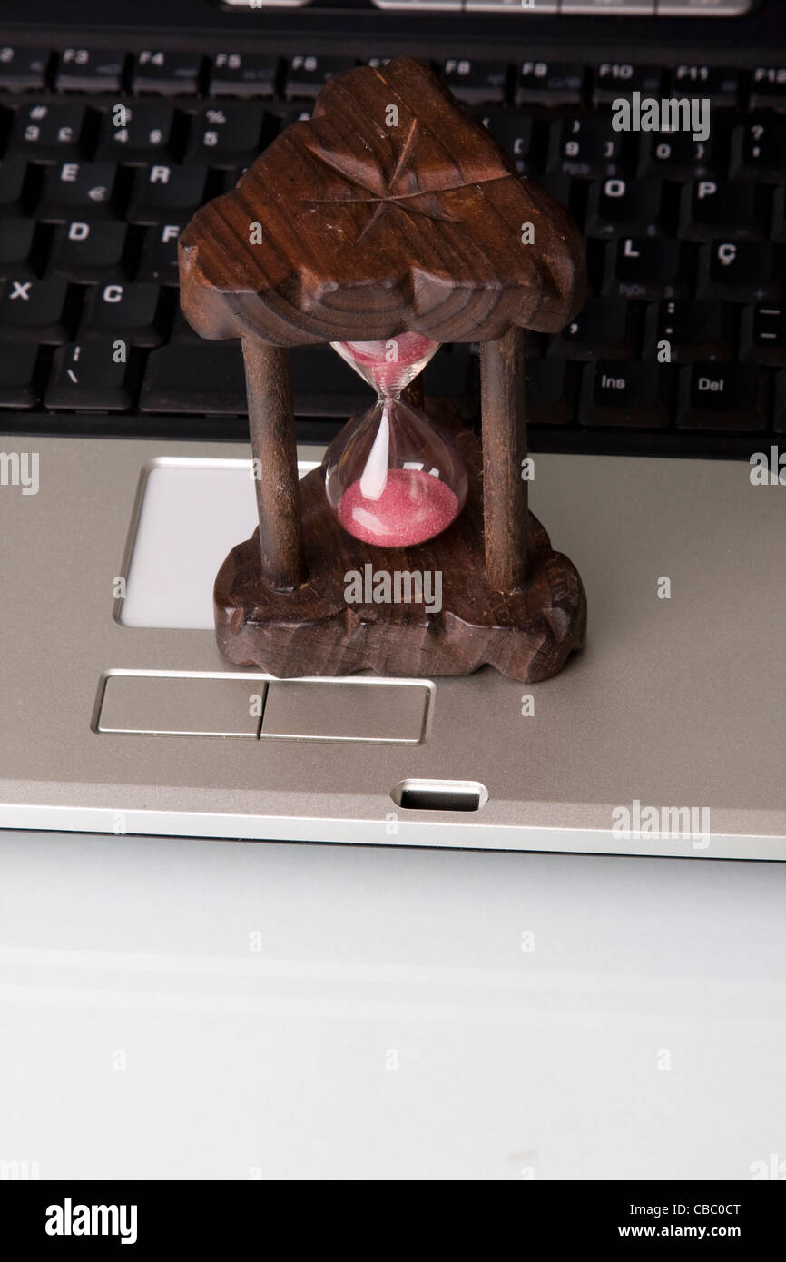 an hourglass in the laptop conceptual speed Stock Photo - Alamy