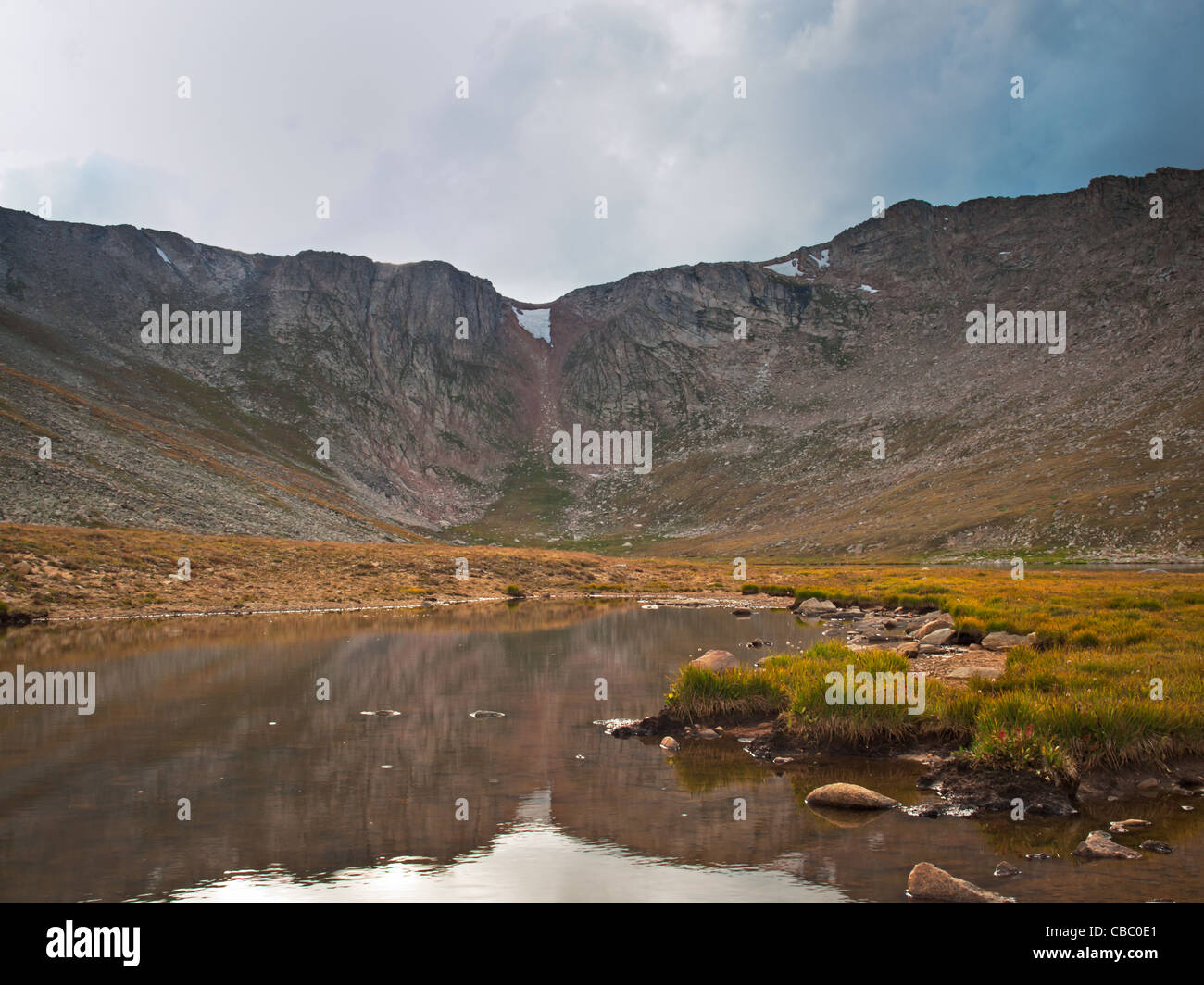 Beautiful Summit Lake reflects towering Mt. Evans and is surrounded by ...