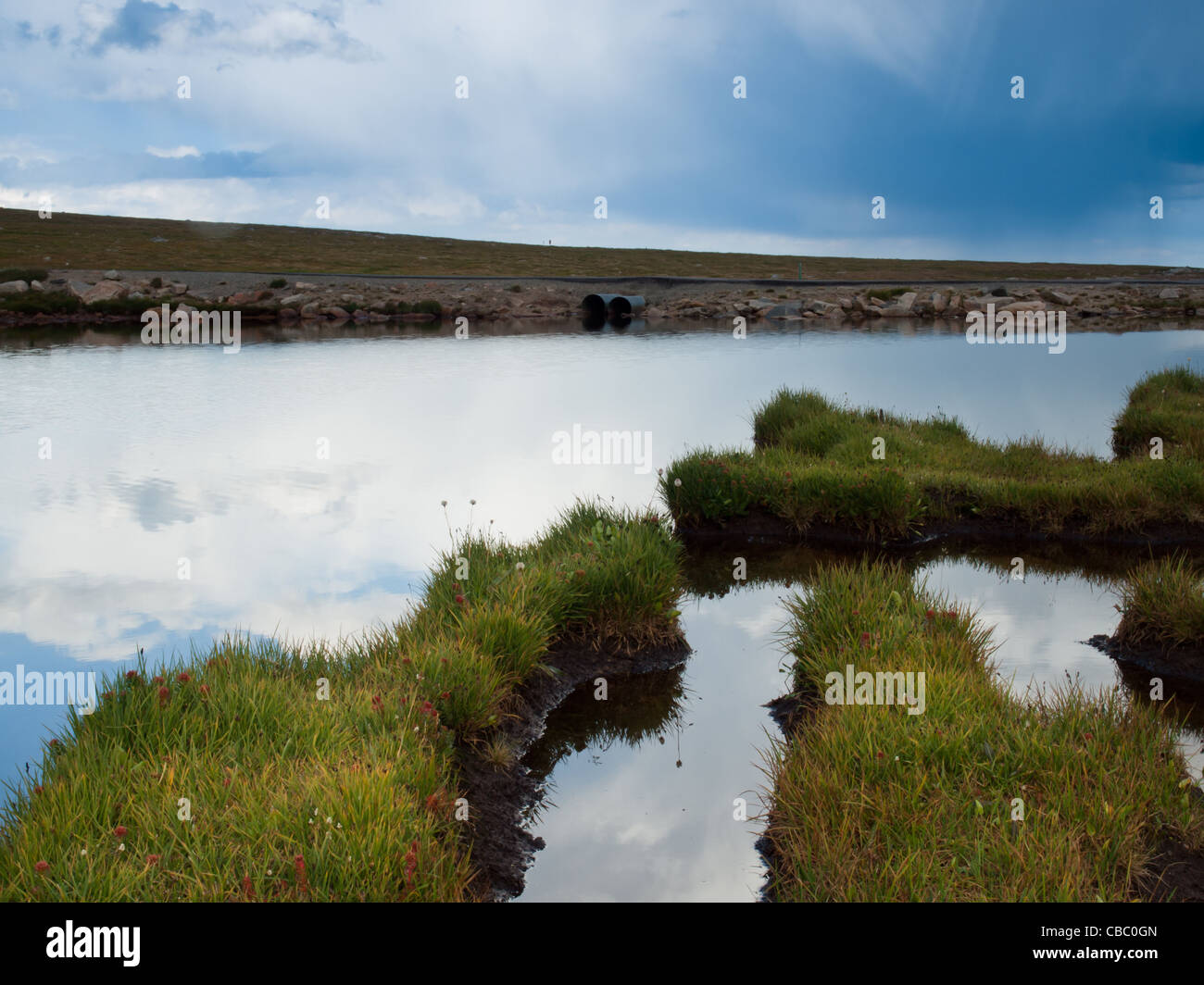 Beautiful Summit Lake reflects towering Mt. Evans and is surrounded by ...