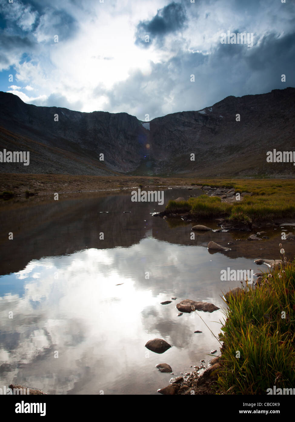 Beautiful Summit Lake reflects towering Mt. Evans and is surrounded by ...