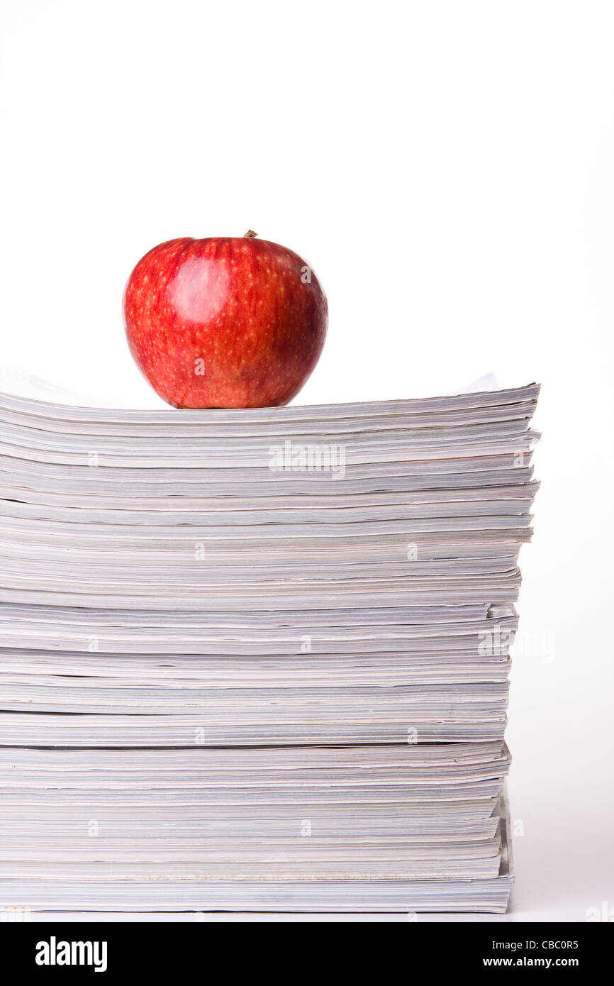 Apple in a stack of books isolated on white Stock Photo - Alamy