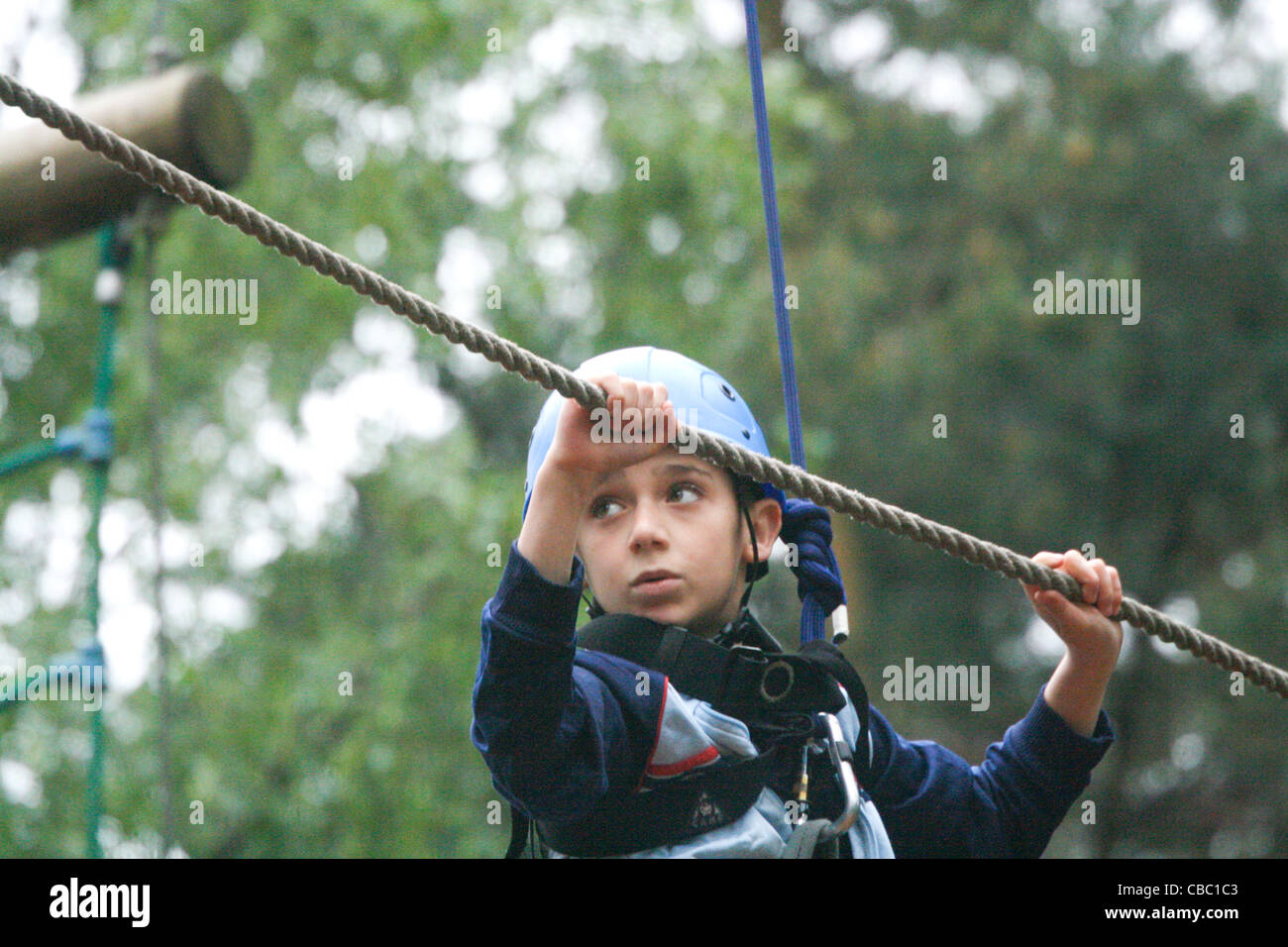 Boy on high rope at activity center Stock Photo - Alamy