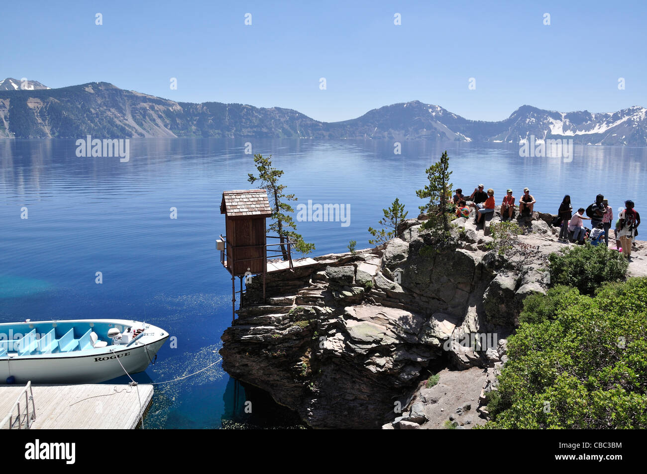 Visitors wait for the ferry boat to cross Crater lake national park ...