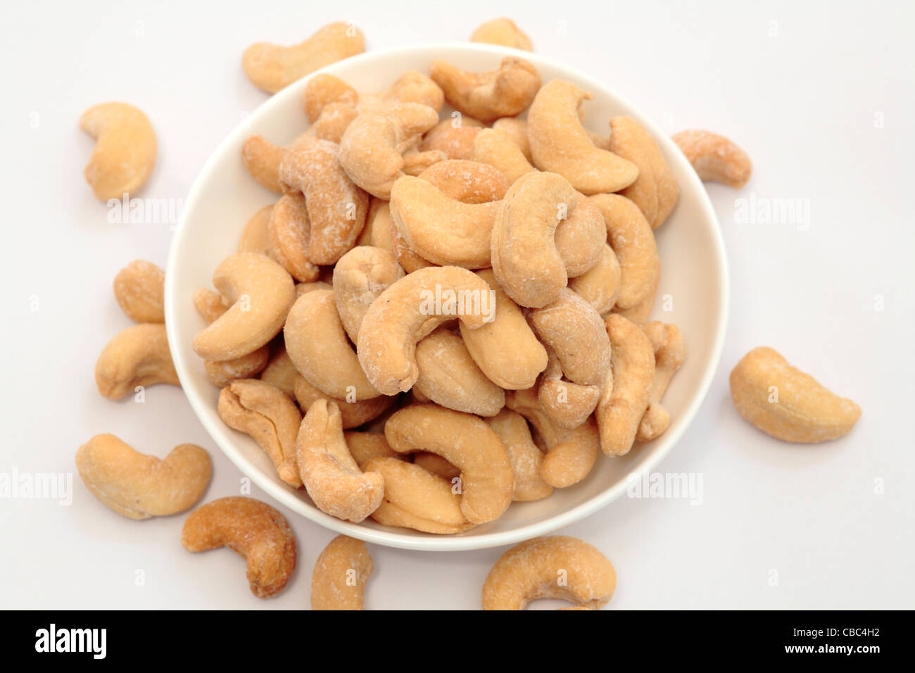 Close-up of whole cashew nuts in a small white dish Stock Photo - Alamy