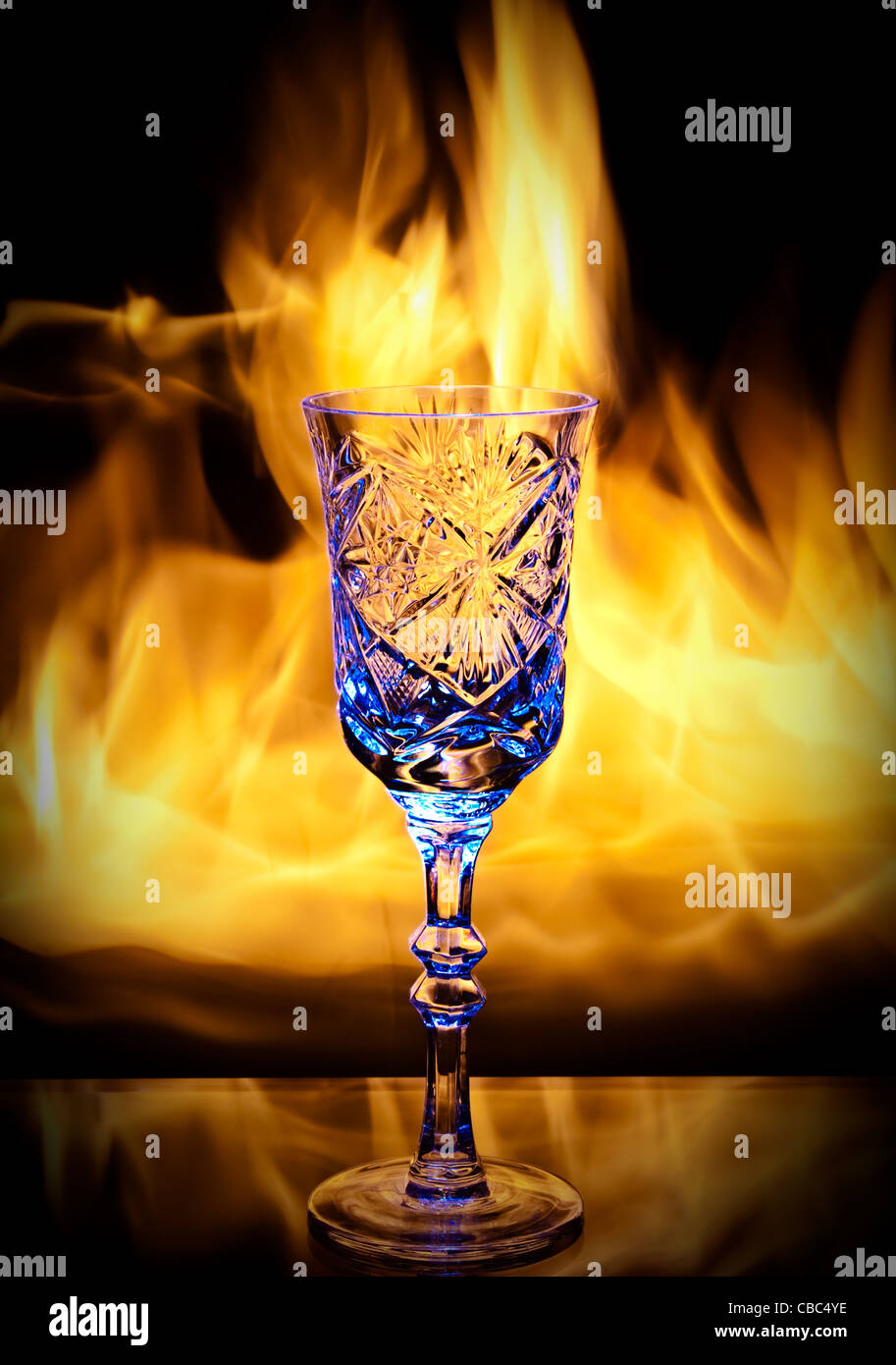photo of the goblet with blue tint of water on real fire background ...