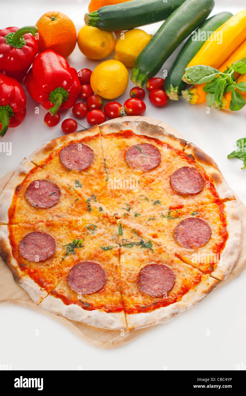 Italian original thin crust pepperoni pizza with fresh vegetables on ...
