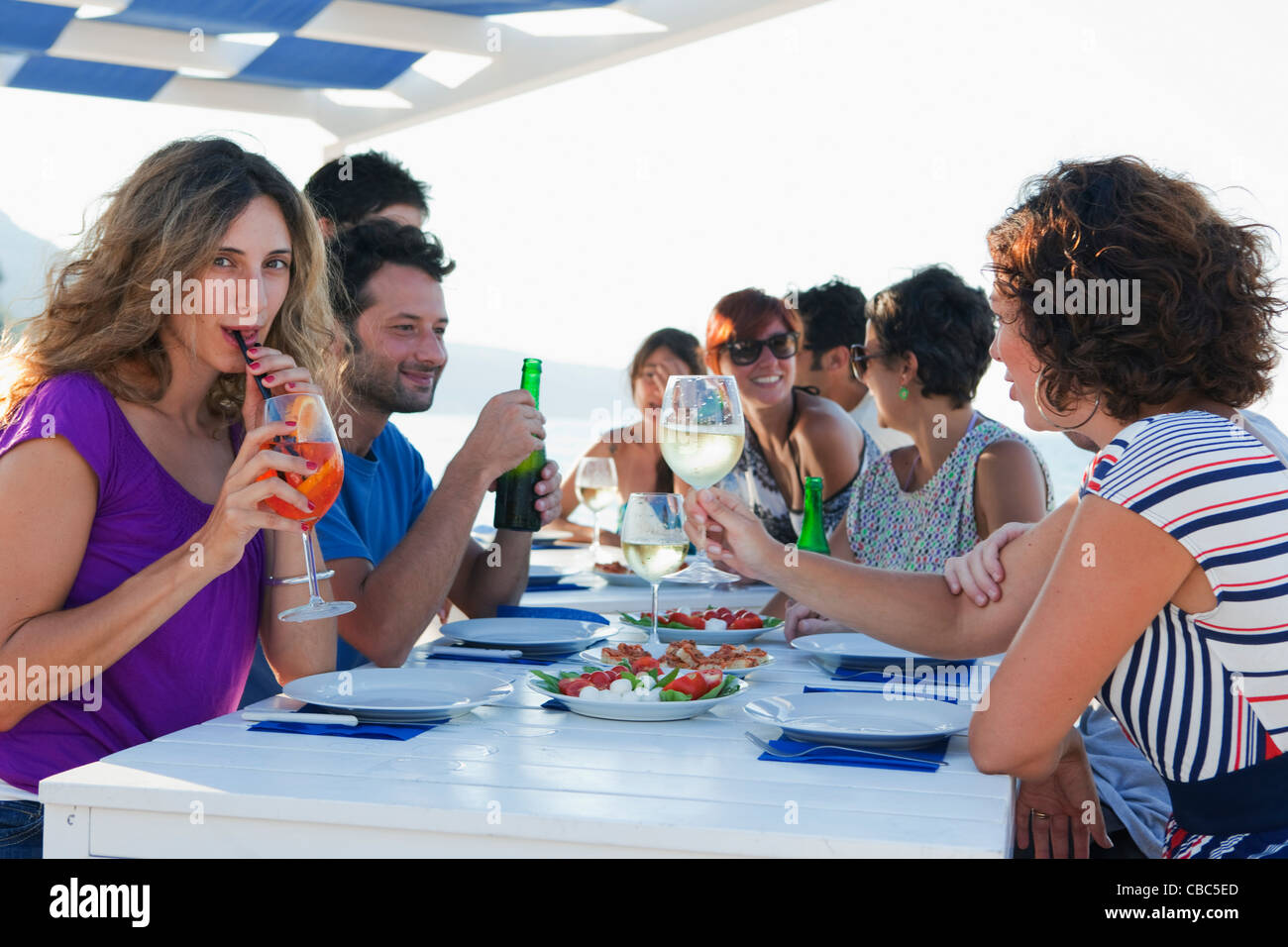 Friends drinking at table outdoors Stock Photo - Alamy