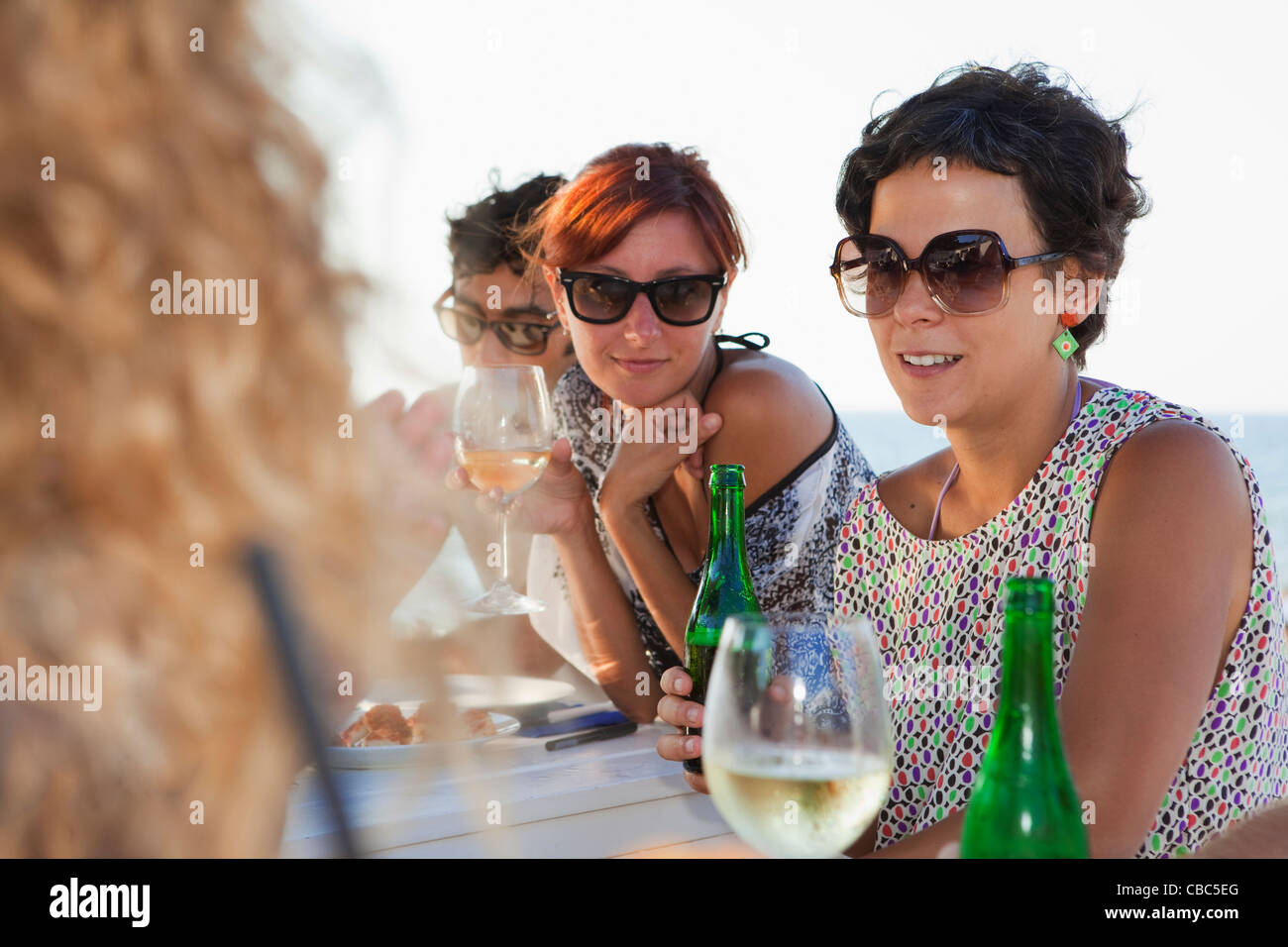 Friends drinking at table outdoors Stock Photo - Alamy