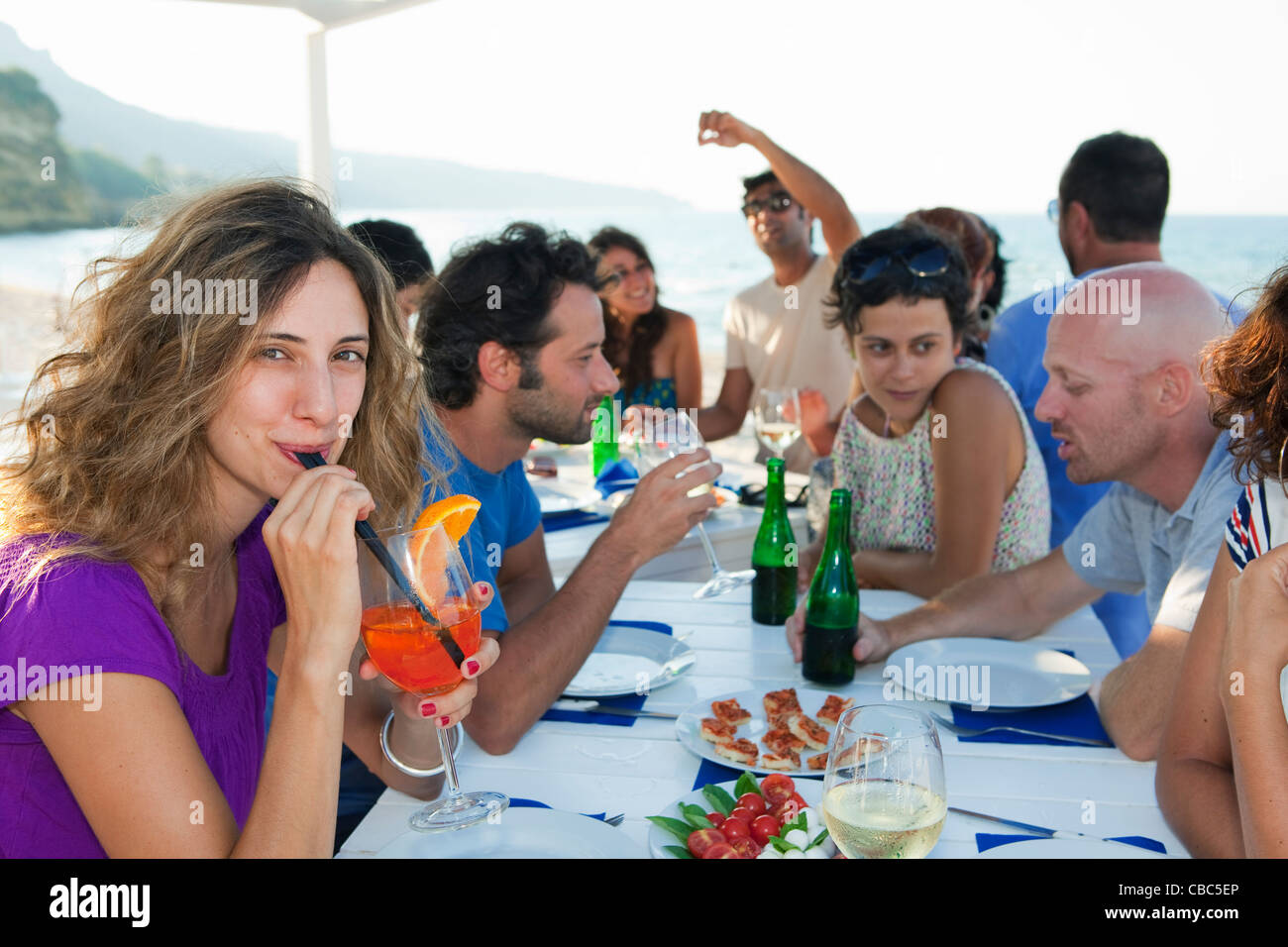 Friends drinking at table outdoors Stock Photo - Alamy