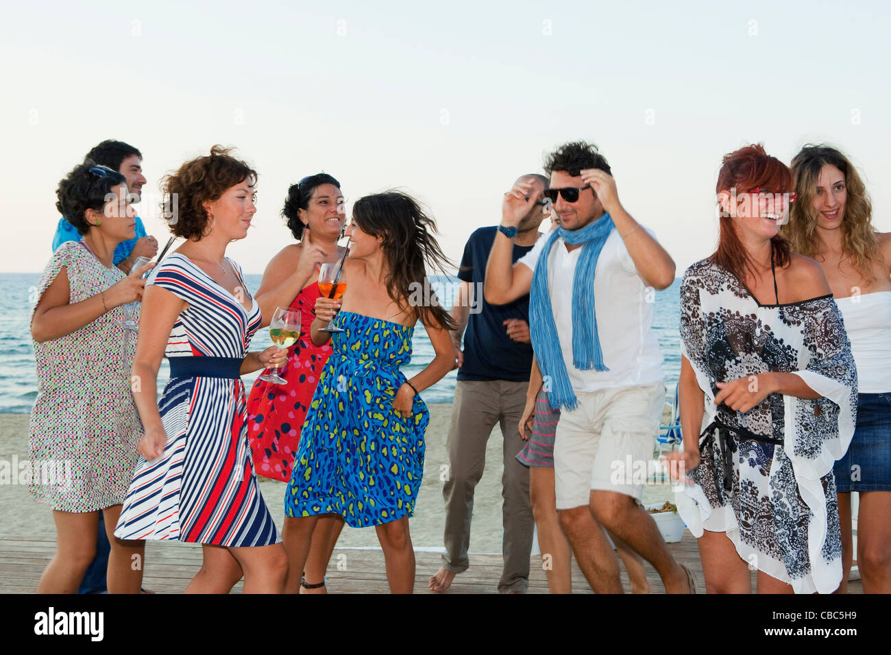 Friends laughing together on beach Stock Photo - Alamy