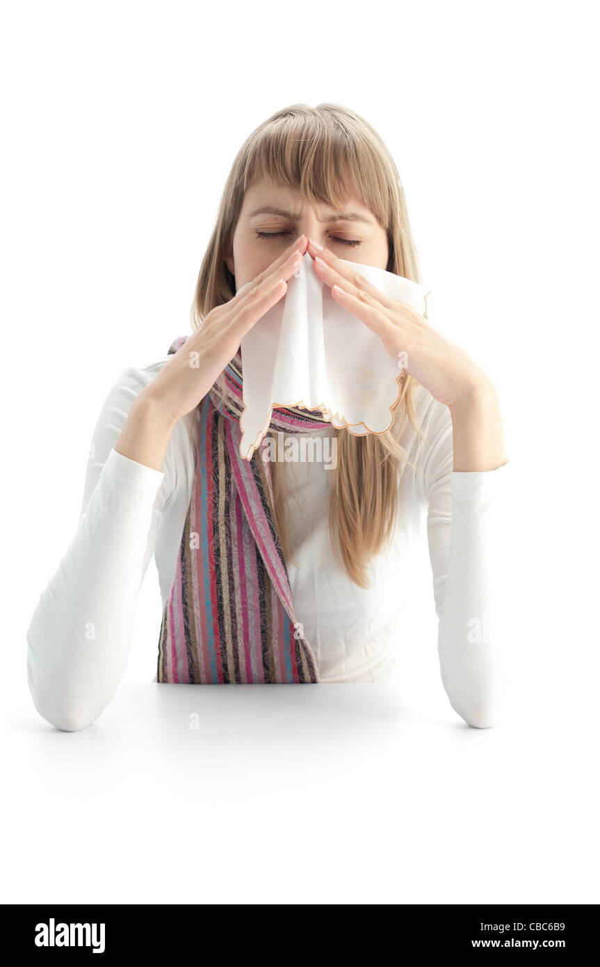 young woman isolated on white background got cold and blowing her nose ...