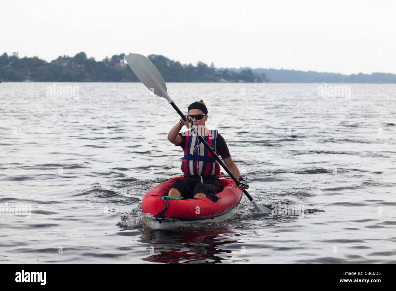 Woman kayaking on still lake Stock Photo - Alamy